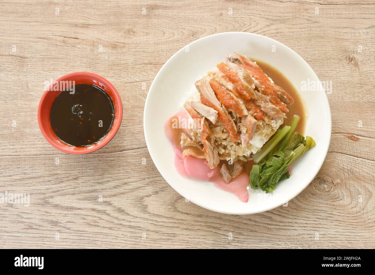 slice roasted duck topping rice with pink pickled ginger and boiled ...