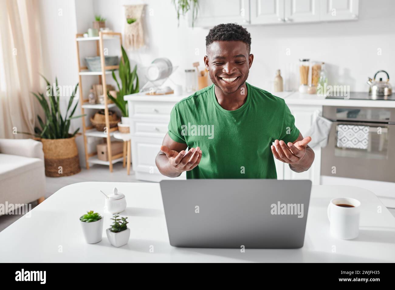 positive african american deaf man using sign language during video ...