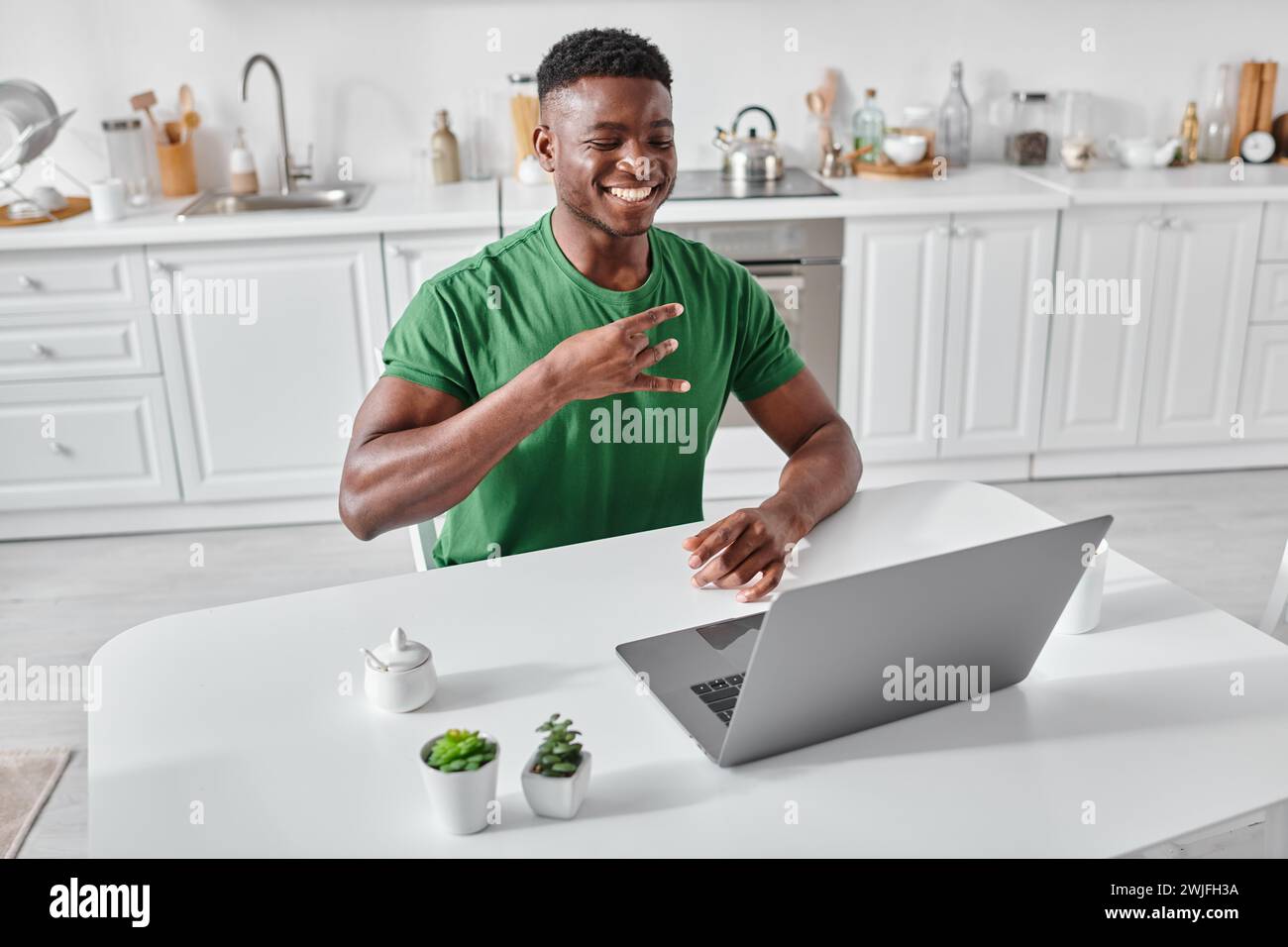 happy deaf african american freelancer using sign language during video ...