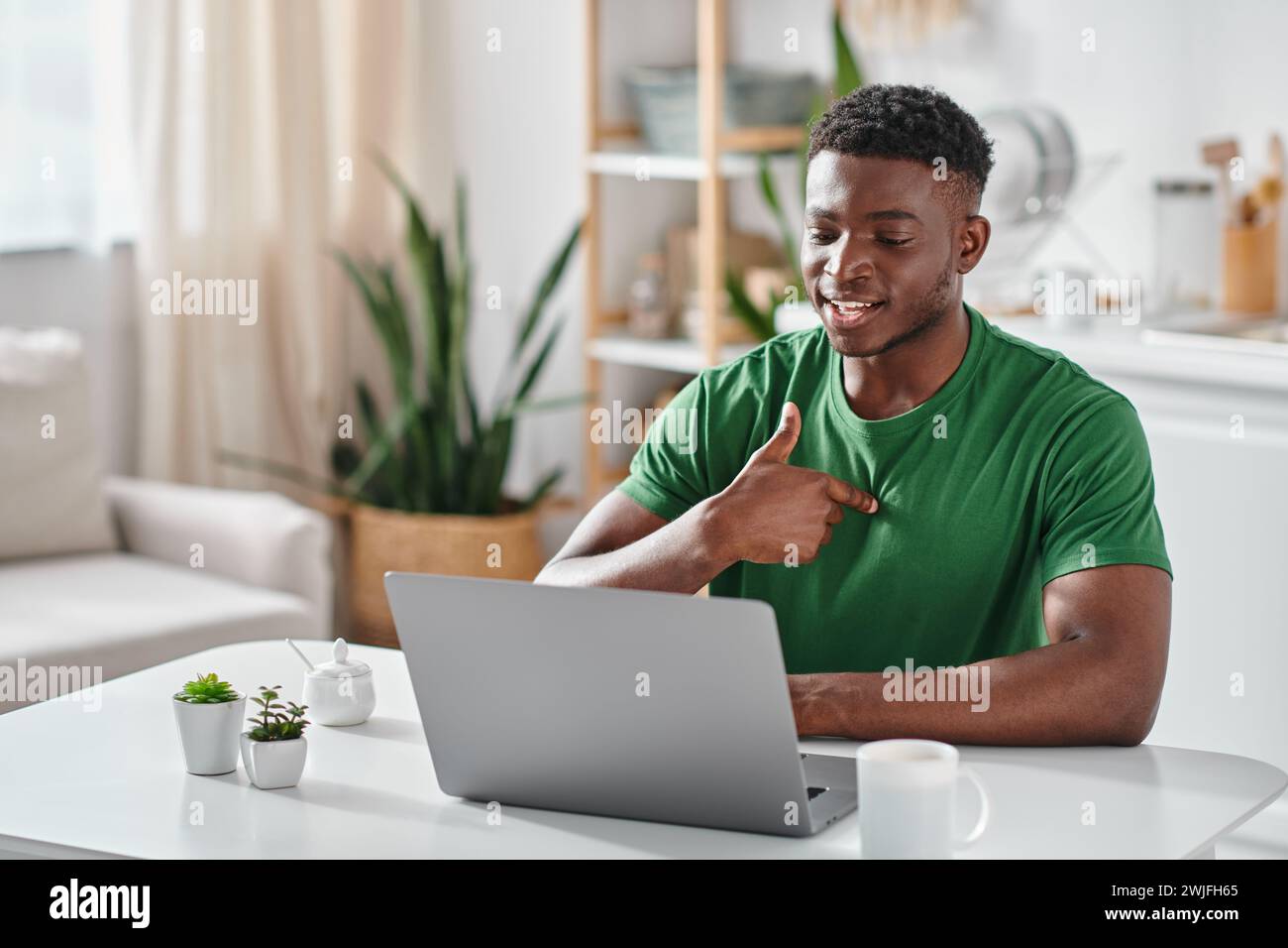 african american man communicating with sigh language during online ...