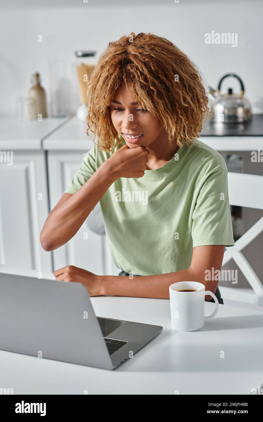 cheerful african american woman using sign language during video call ...