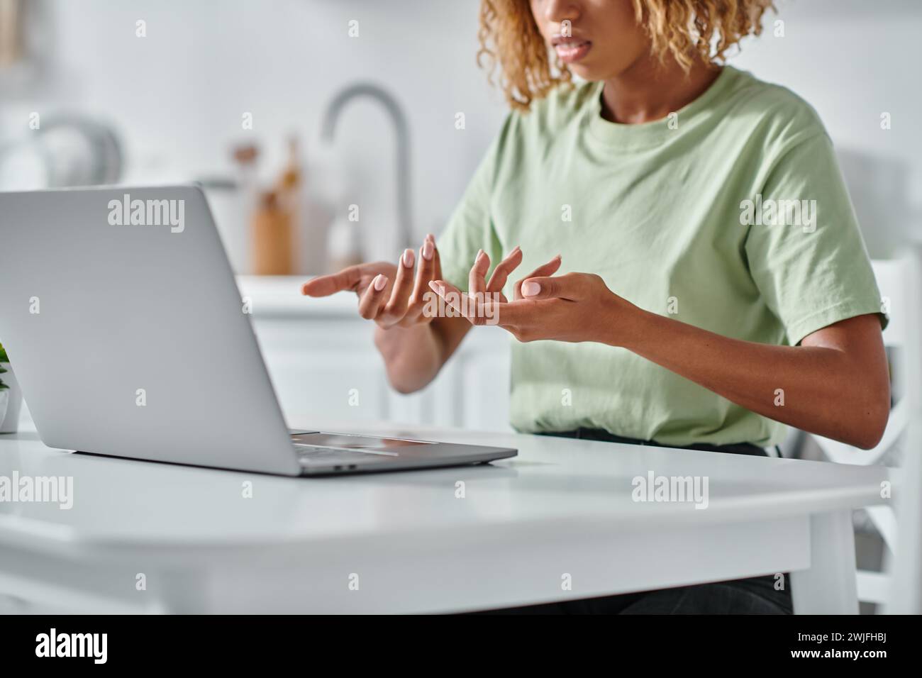 cropped african american woman in braces using sign language during ...