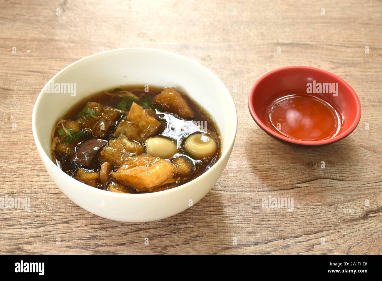 braised fish maw with bamboo shoot topping boiled egg in red gravy soup ...