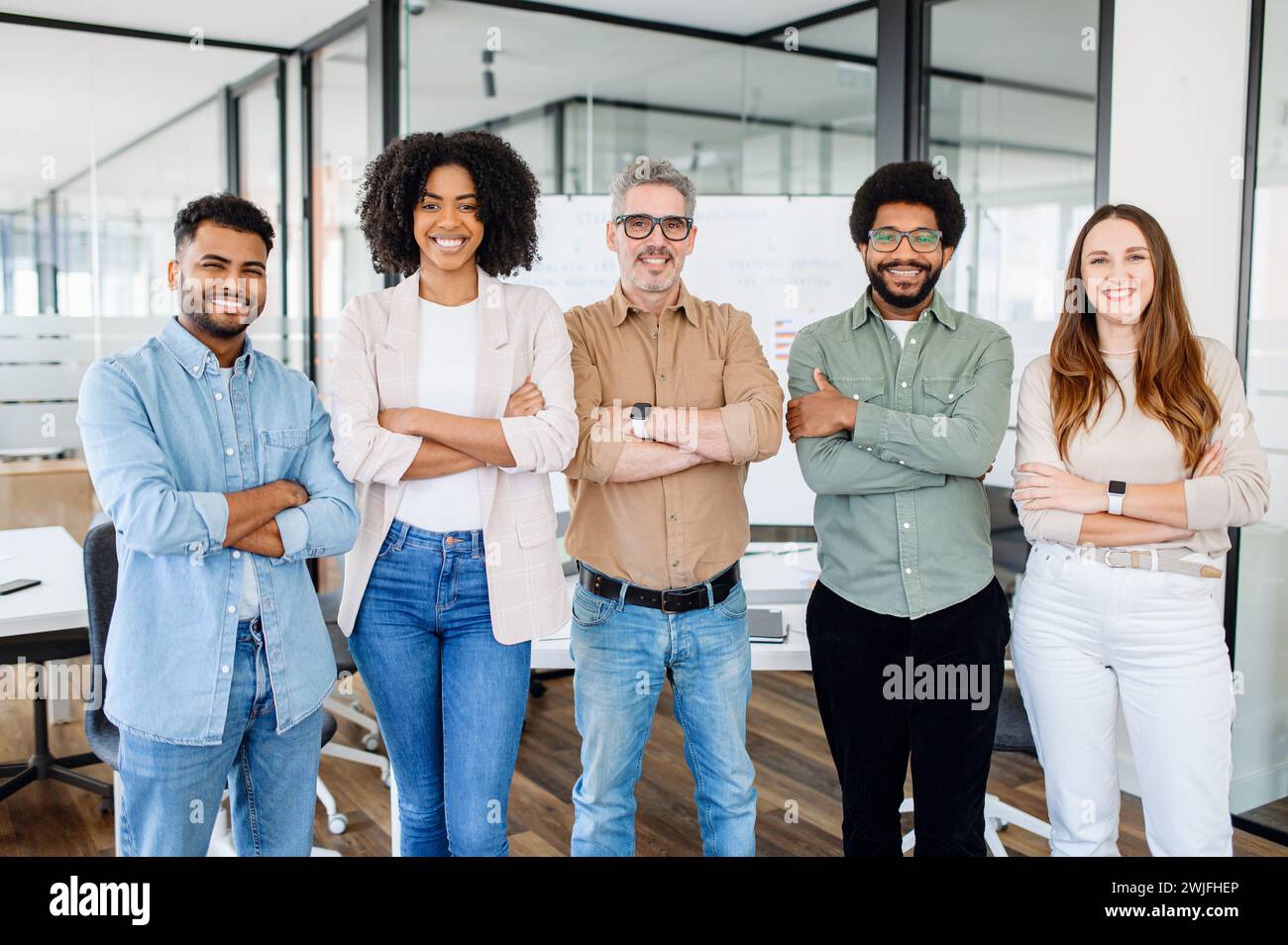 A dynamic team of five, radiating positivity and diversity, stand ...