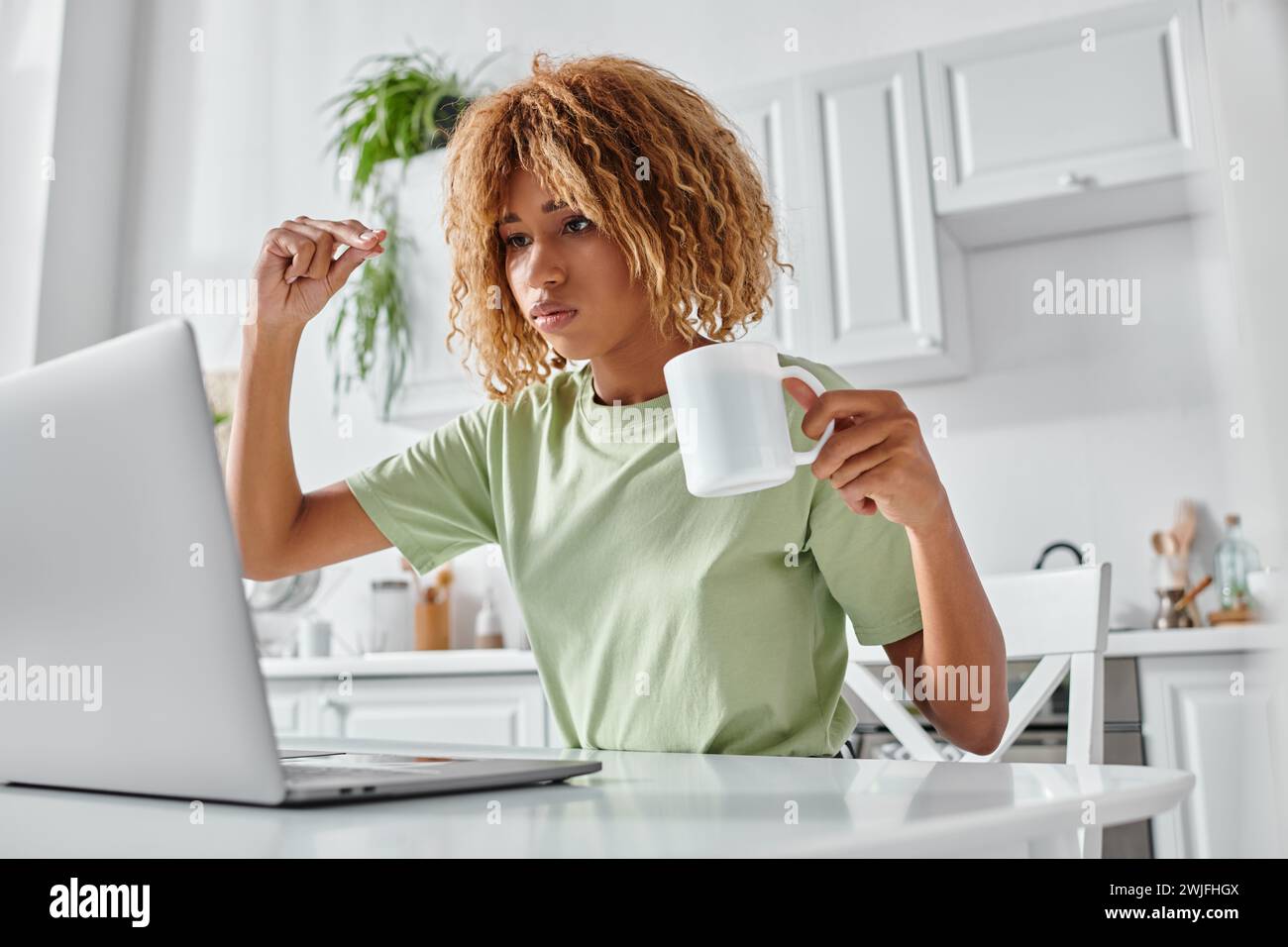 serious african american woman using sign language during video call ...