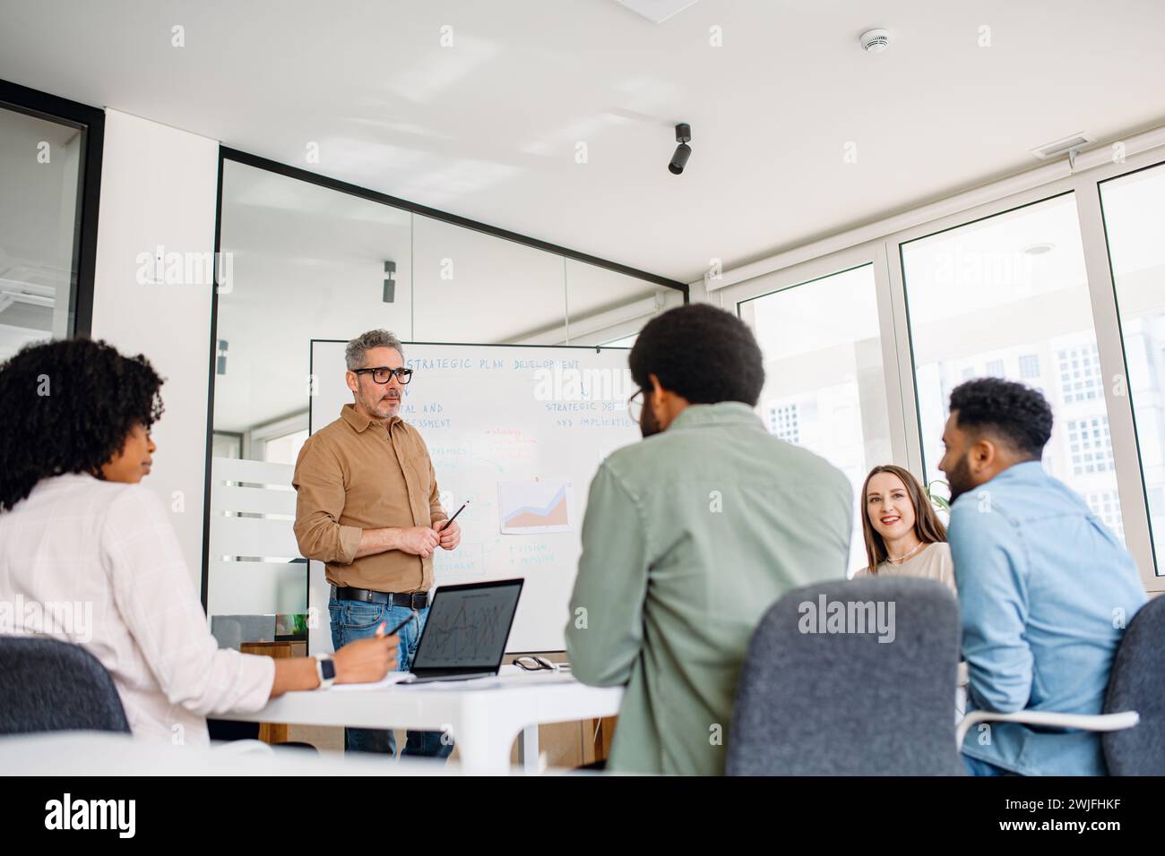 Group around whiteboard in office hi-res stock photography and images ...