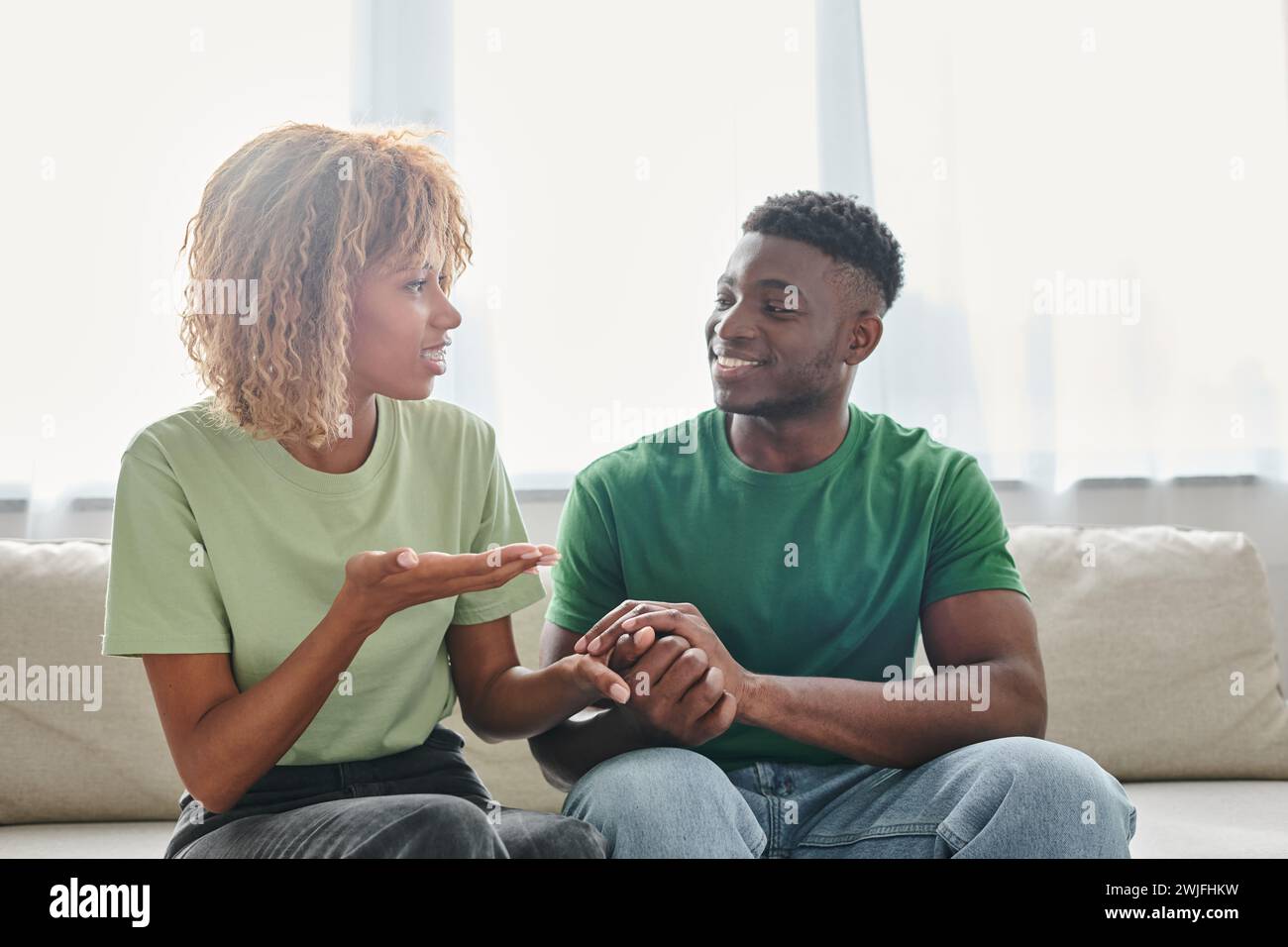 happy African American woman communicating with sign language while ...