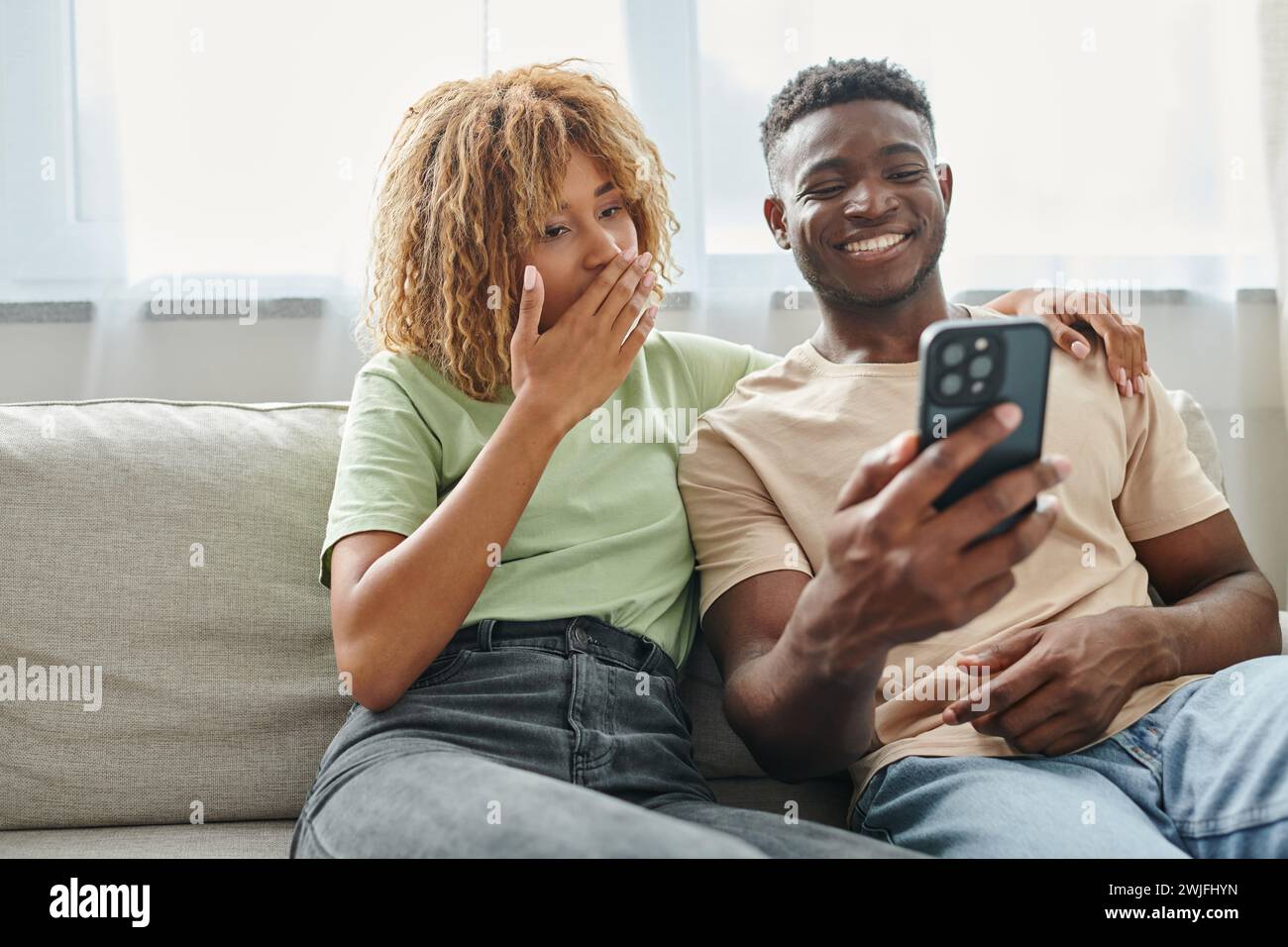 happy african american couple laughing while video chatting on a ...