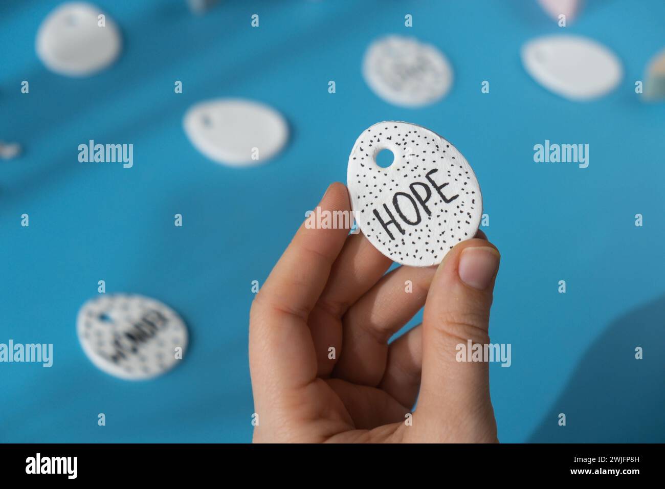 Workshop writing word HOPE on EASTER clay egg Creator is using white ...