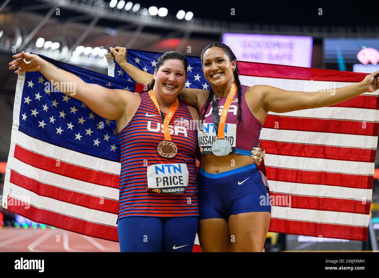 Janee' KASSANAVOID and DeAnna PRICE celebrating his medal with the flag ...
