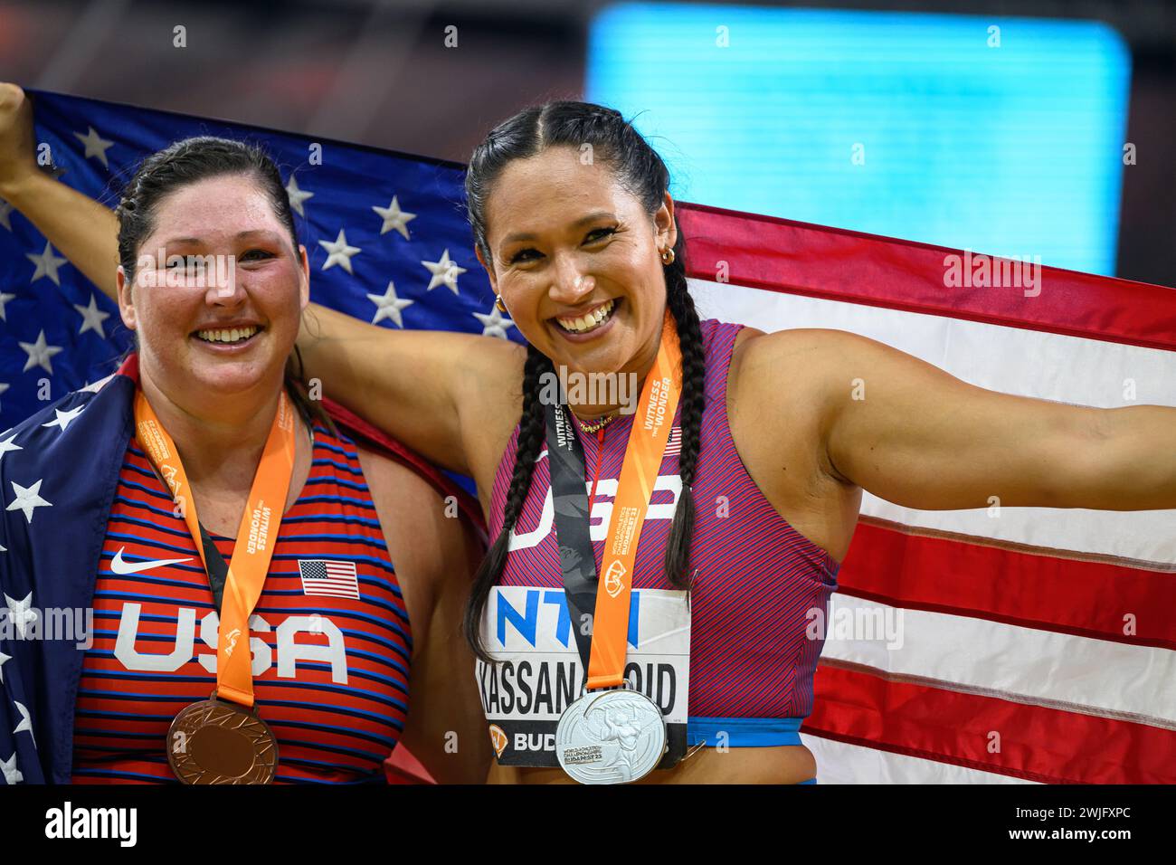 Janee' KASSANAVOID and DeAnna PRICE celebrating his medal with the flag ...
