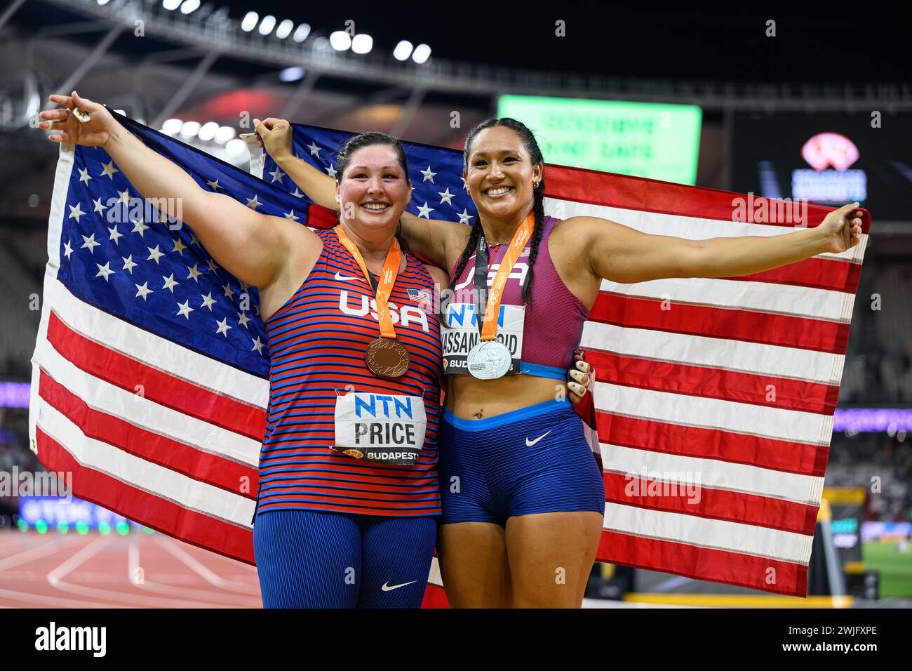 Janee' KASSANAVOID and DeAnna PRICE celebrating his medal with the flag ...