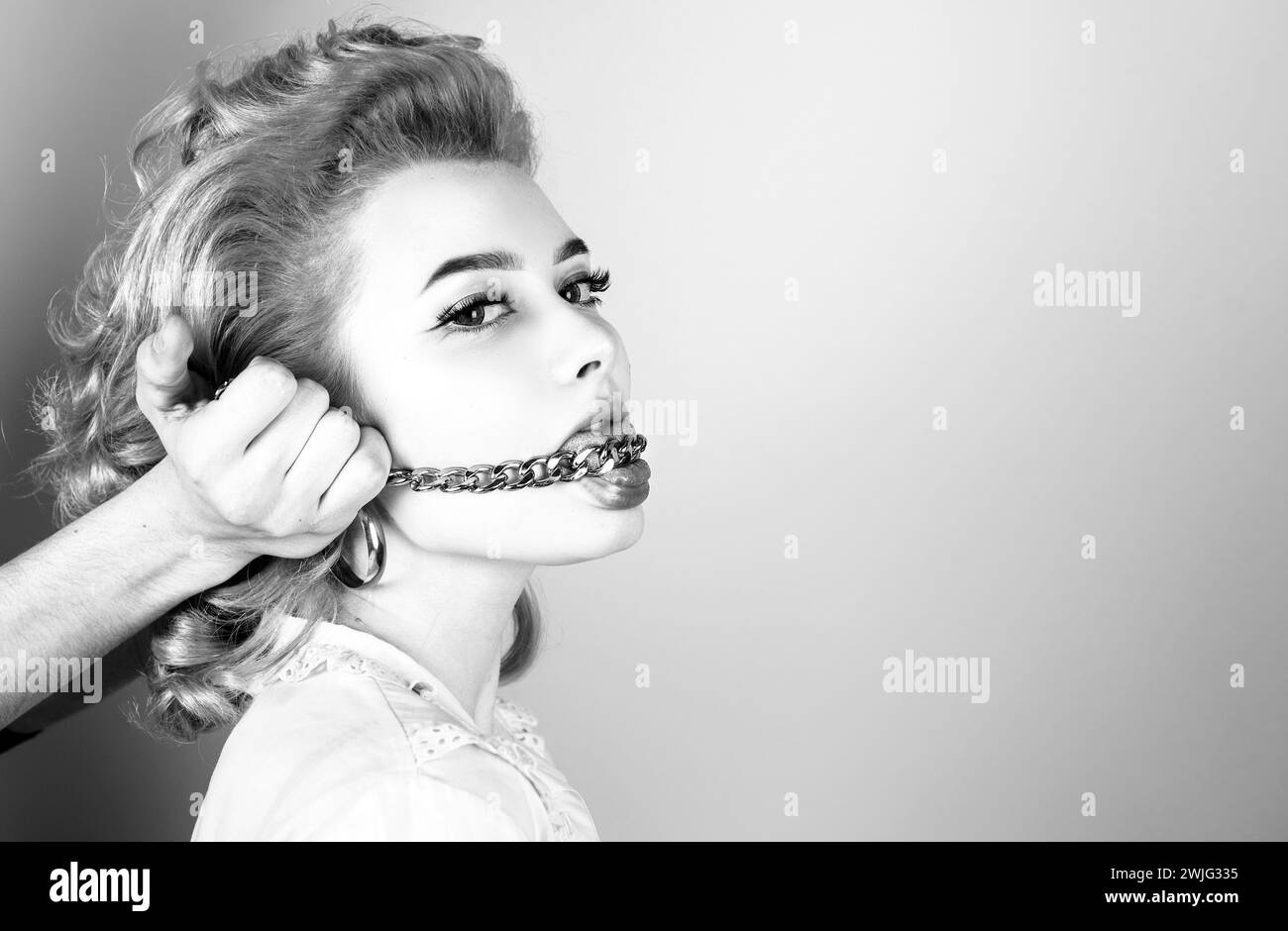 Redhead woman close up portrait with golden chain in mouth Stock Photo ...