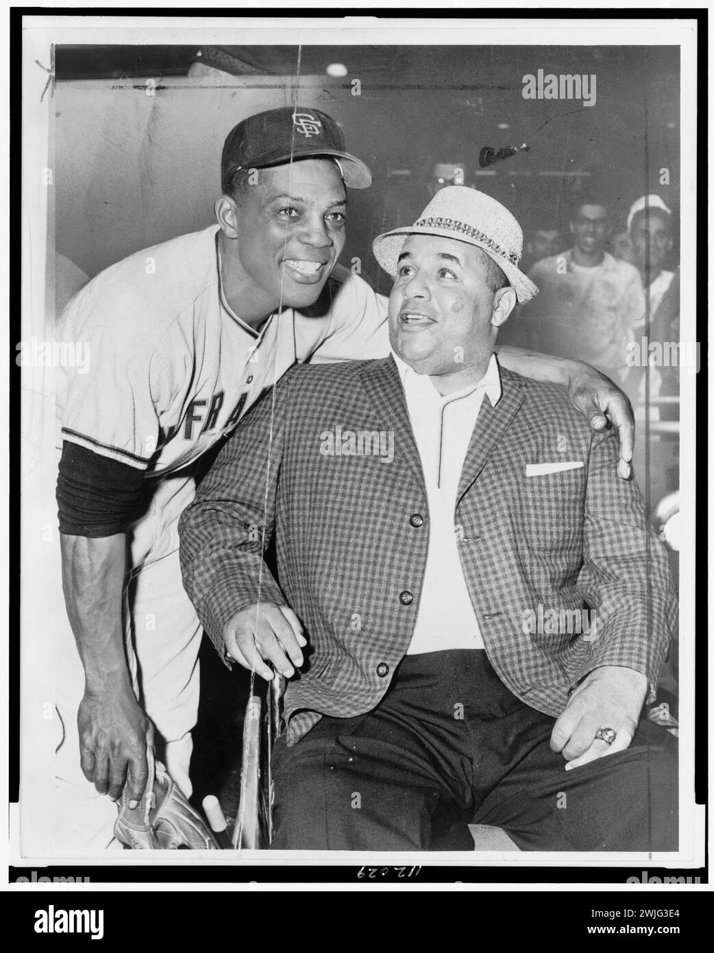 Title Willie Mays, standing, wearing baseball uniform, with arm around ...