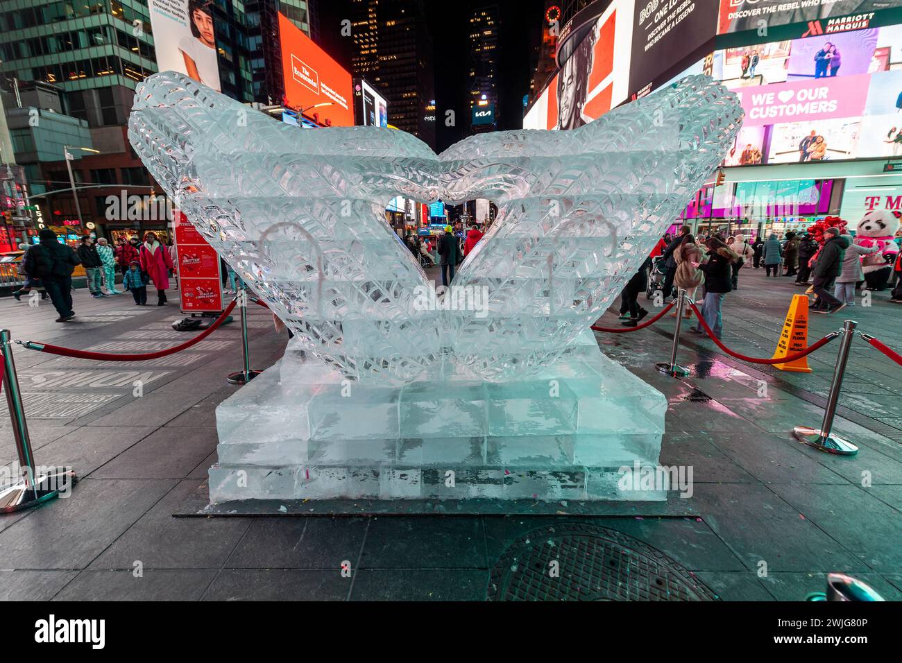 Tourists crowd Lovie Pignata’s “Smitten” ice sculpture, the winner of ...