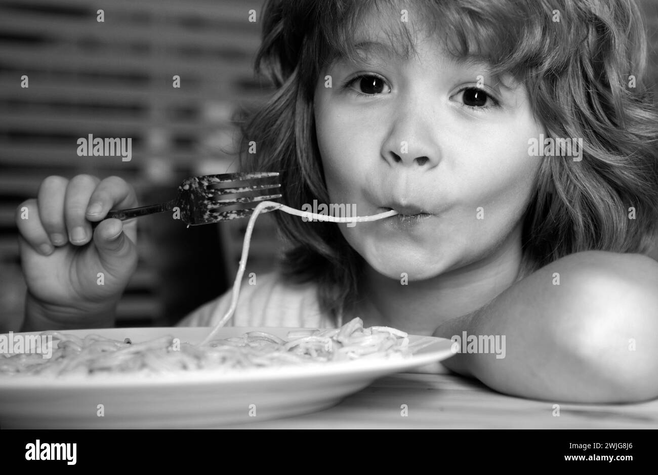 Kids eating pasta, spaghetti, close up cute funny child Stock Photo - Alamy