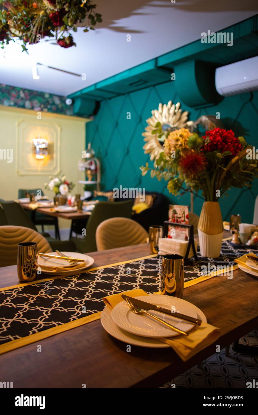 Elegant table setting with floral centerpiece, copper accents, and ...