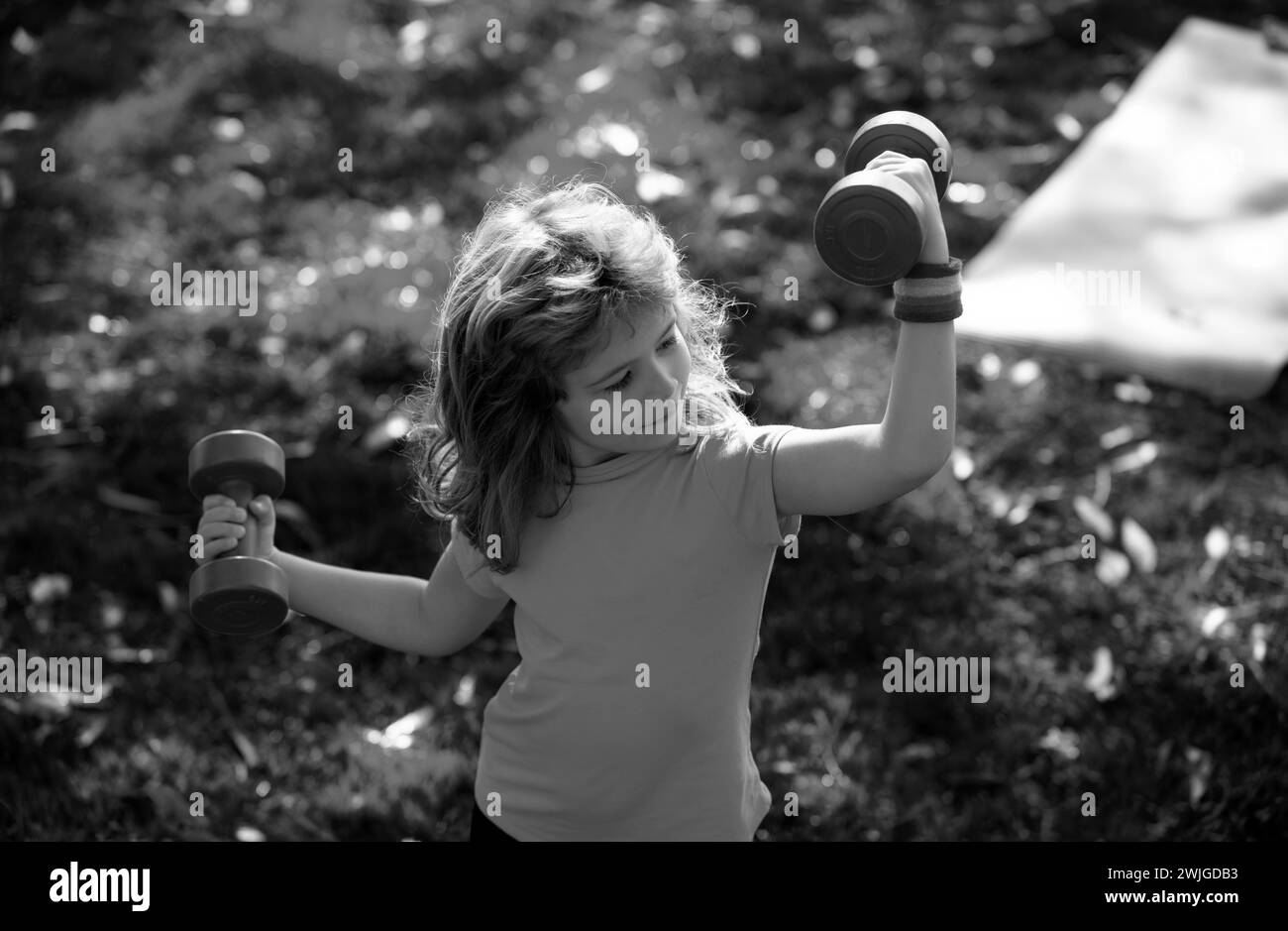 Boy is doing exercises to develop muscles. Child is doing exercises ...