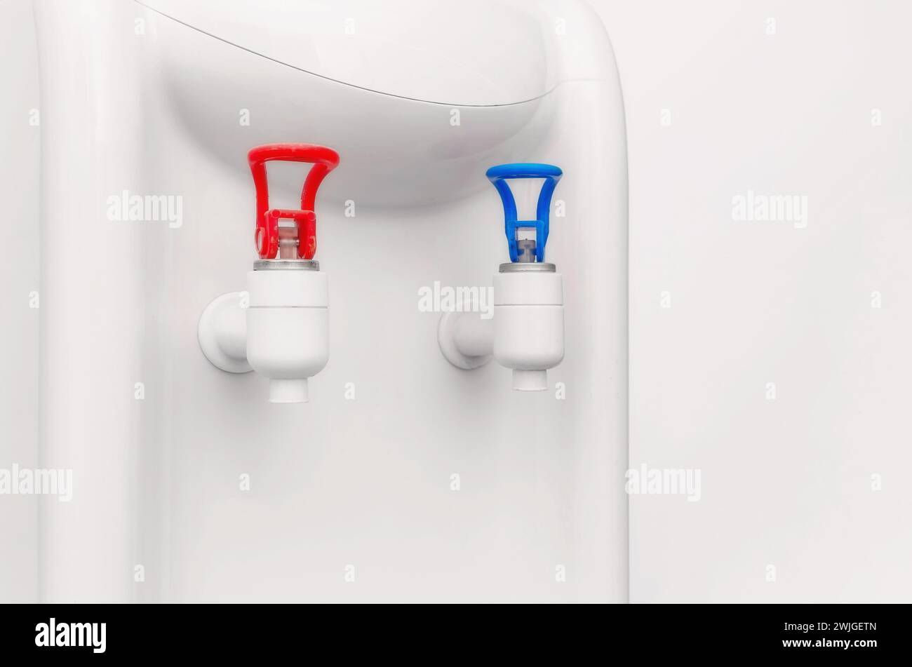 Plastic taps in a water office cooler. Cold and hot water Stock Photo ...