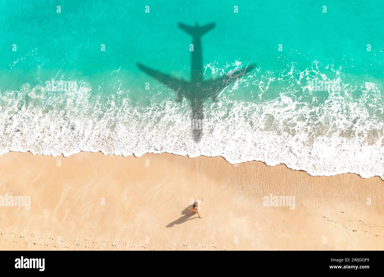 Airplane shadow flying over beautiful exotic tropical beach with woman sunbathing on a sunny cay ...