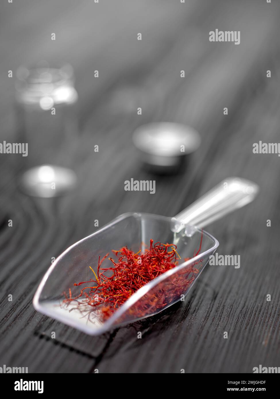 Dried saffron in spoon on black background Stock Photo - Alamy