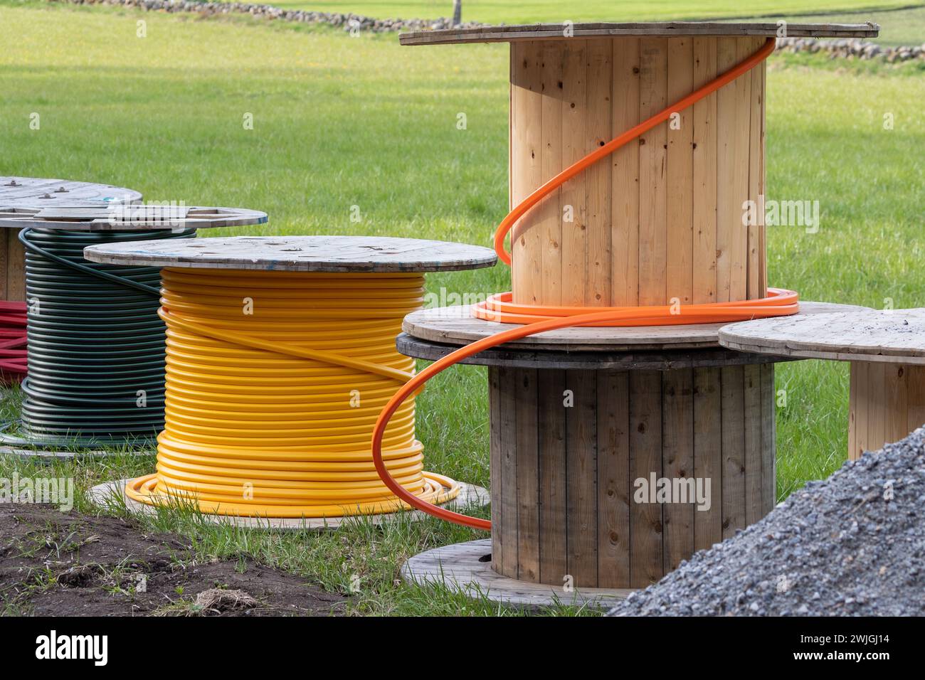Cable on wooden drums with a grass field backgroundShot in Sweden ...