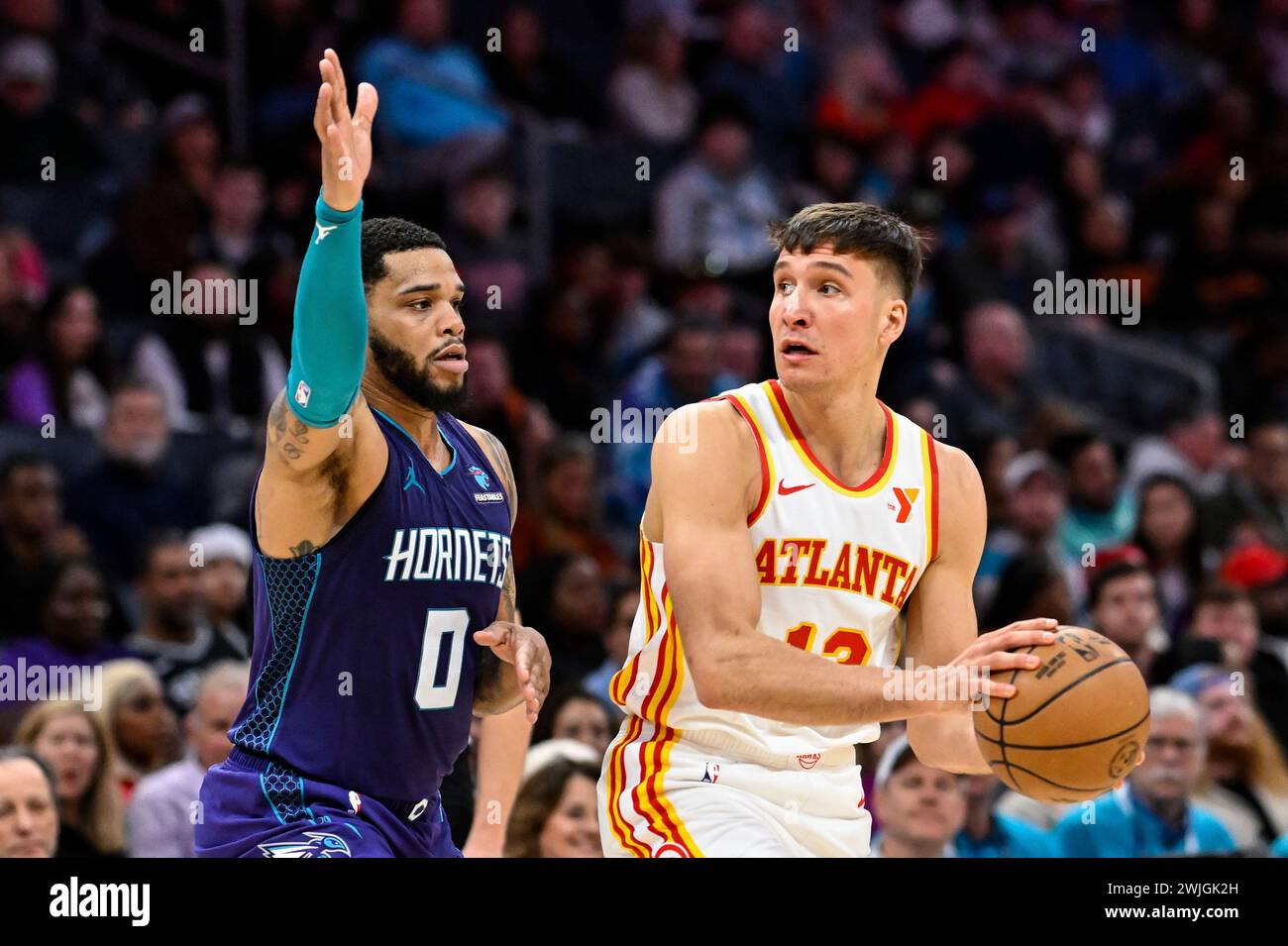 Charlotte Hornets forward Miles Bridges (0) defends Atlanta Hawks guard Bogdan Bogdanovic during ...