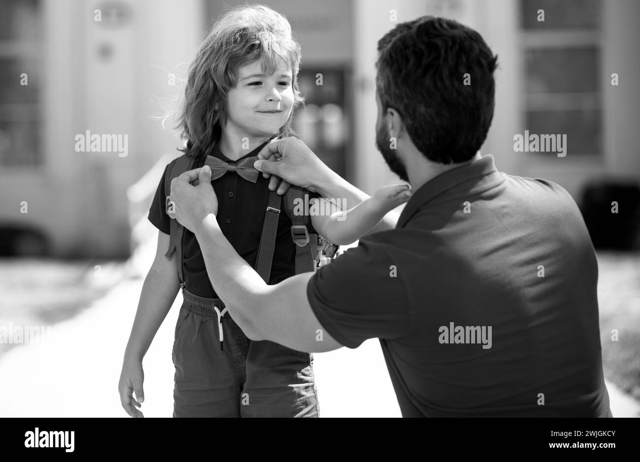 Funny nerd. Parent helping kids put backpack on preparing go to school, loving family dad ...