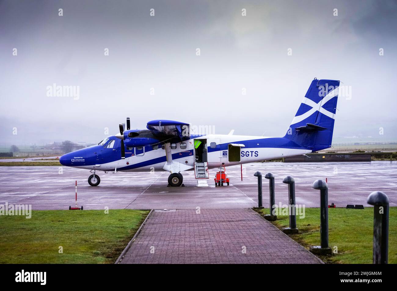 A Loganair Twin Otter aircraft parked on the runway after arrival at ...