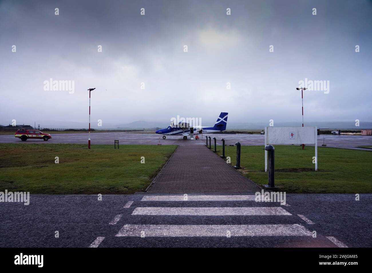 A Loganair Twin Otter aircraft parked on the runway after arrival at ...