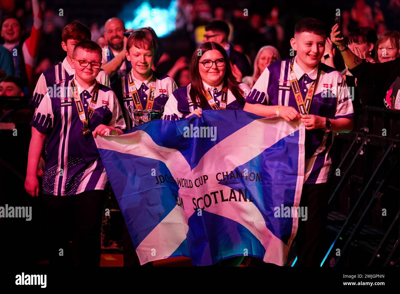 Members of the Scotland junior darts champions hold a the Scottish flag ...