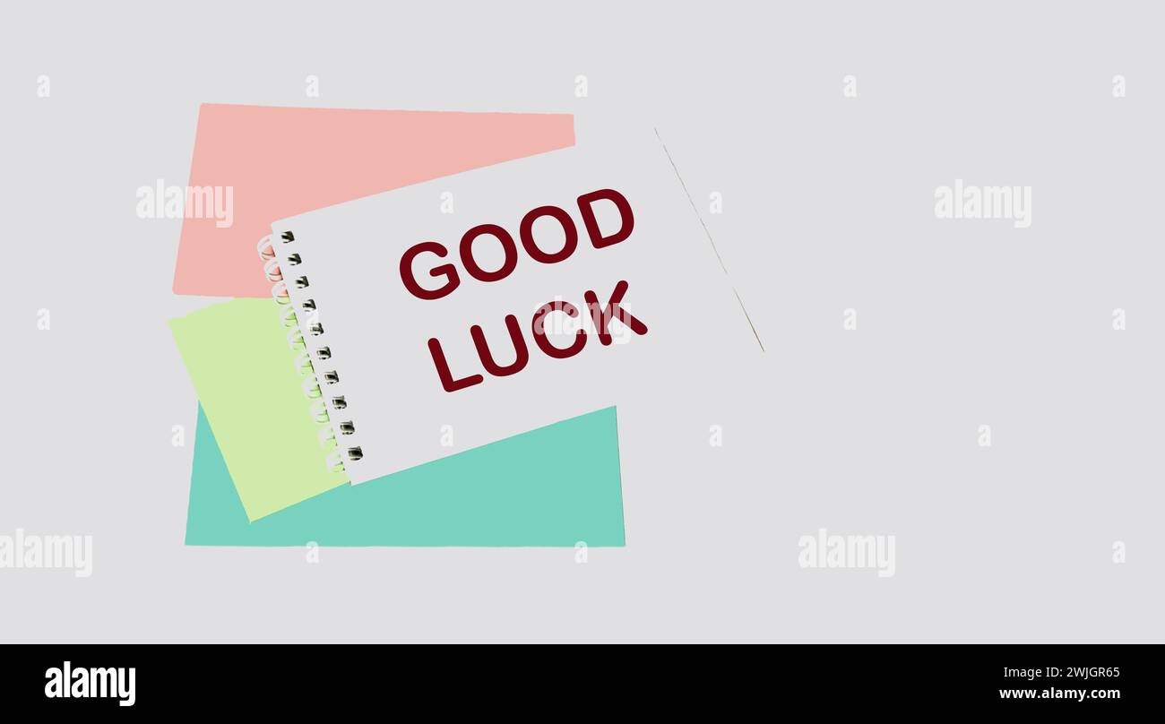 Good luck text on notepad and group of stickers on white background ...