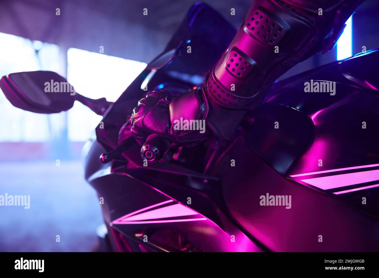 Motor biker driving sport motorcycle in neon light Stock Photo - Alamy
