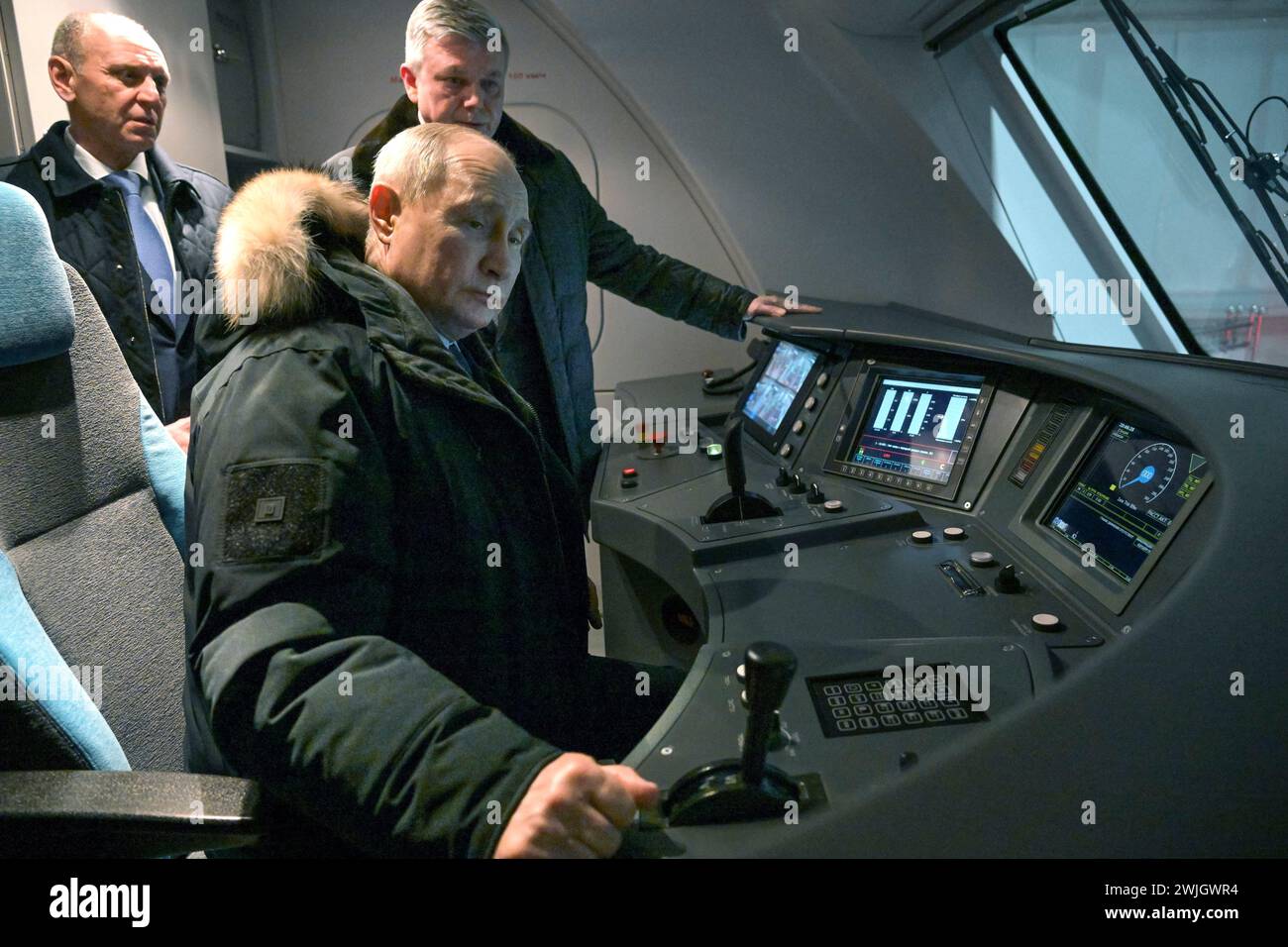 Russian President Vladimir Putin sits in the locomotive cabin as he ...