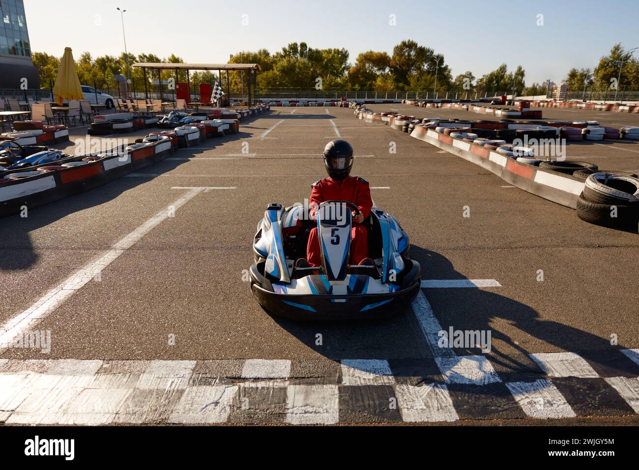 Competitive man racing in go-carts at finish of motor race track Stock ...