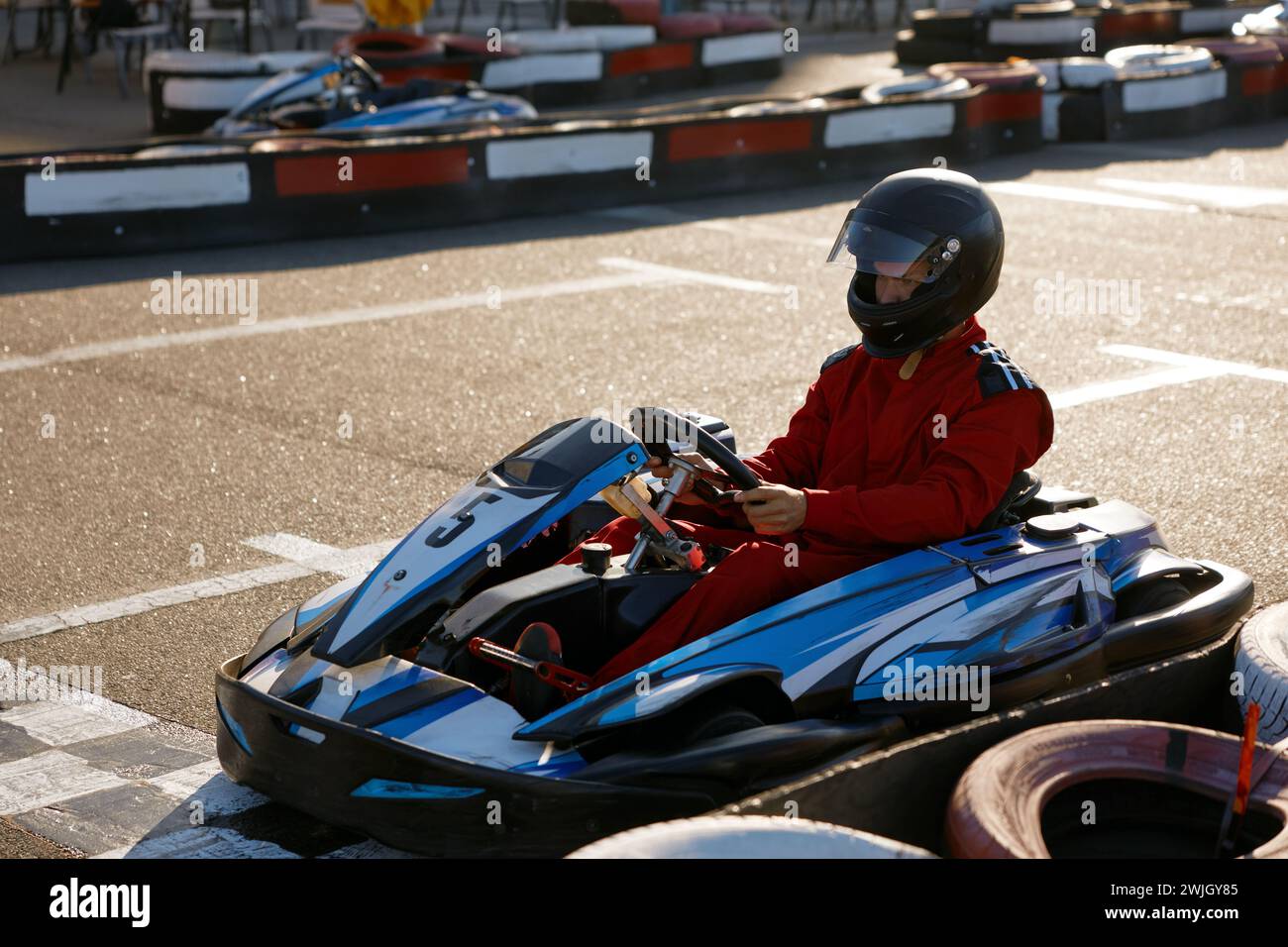 Diver racing on go-cart track outdoors enjoying competitive activity ...