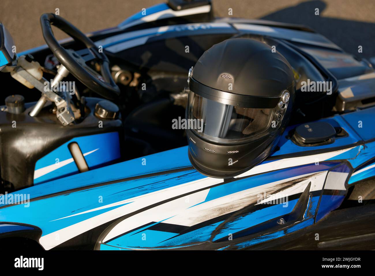 Closeup helmet on go-cart car at automotive speedway stadium Stock ...