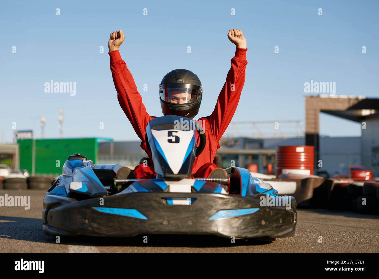 Happy go-cart driver raising hands up rejoicing and celebrating win ...