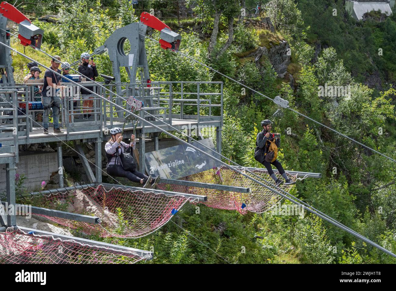 Riders on the Flåm Zipline drop down into the Myrdal to Flåm valley ...