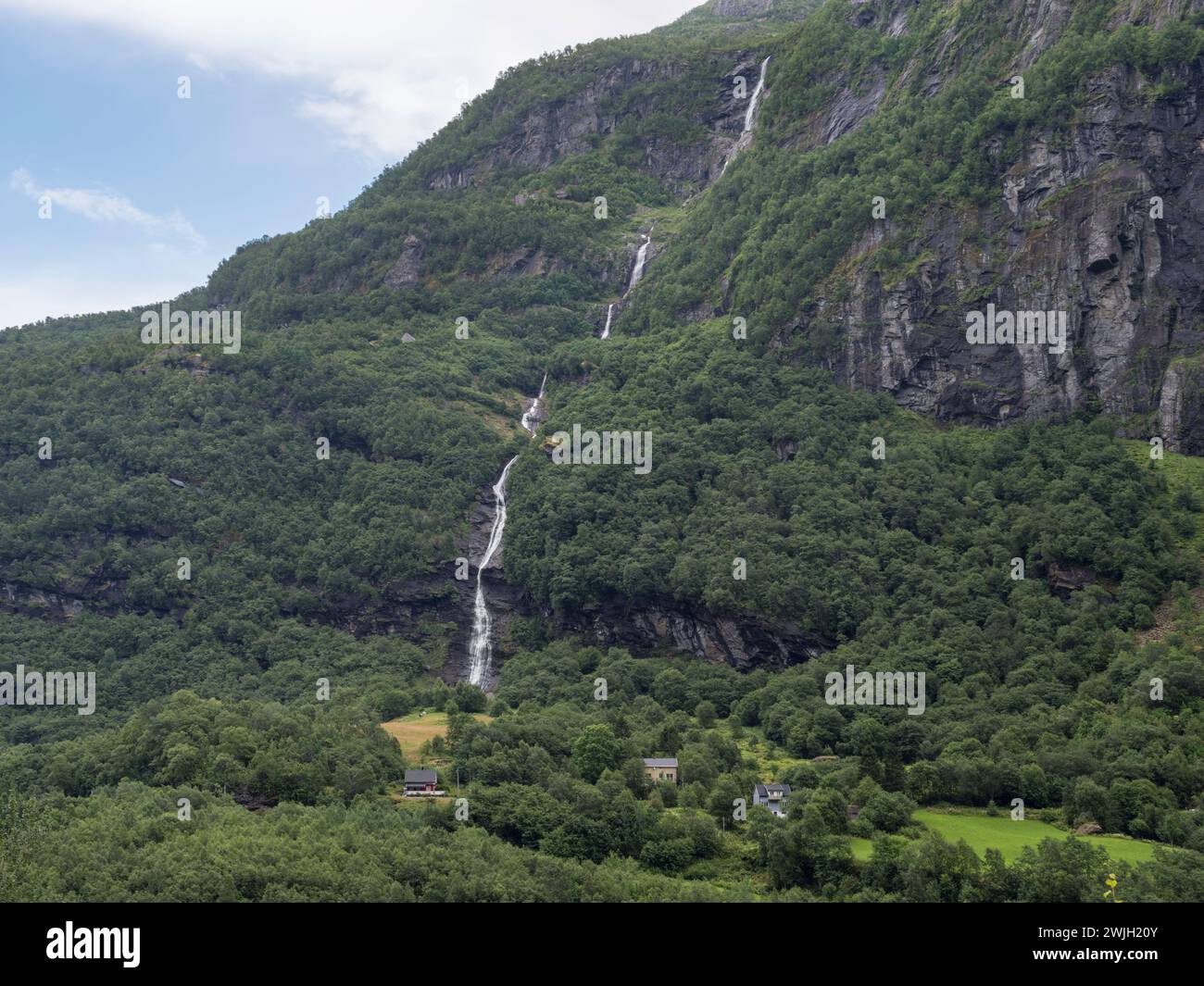 Tall waterfall with a 'tiny' house to show scale in Aurlandsfjord ...
