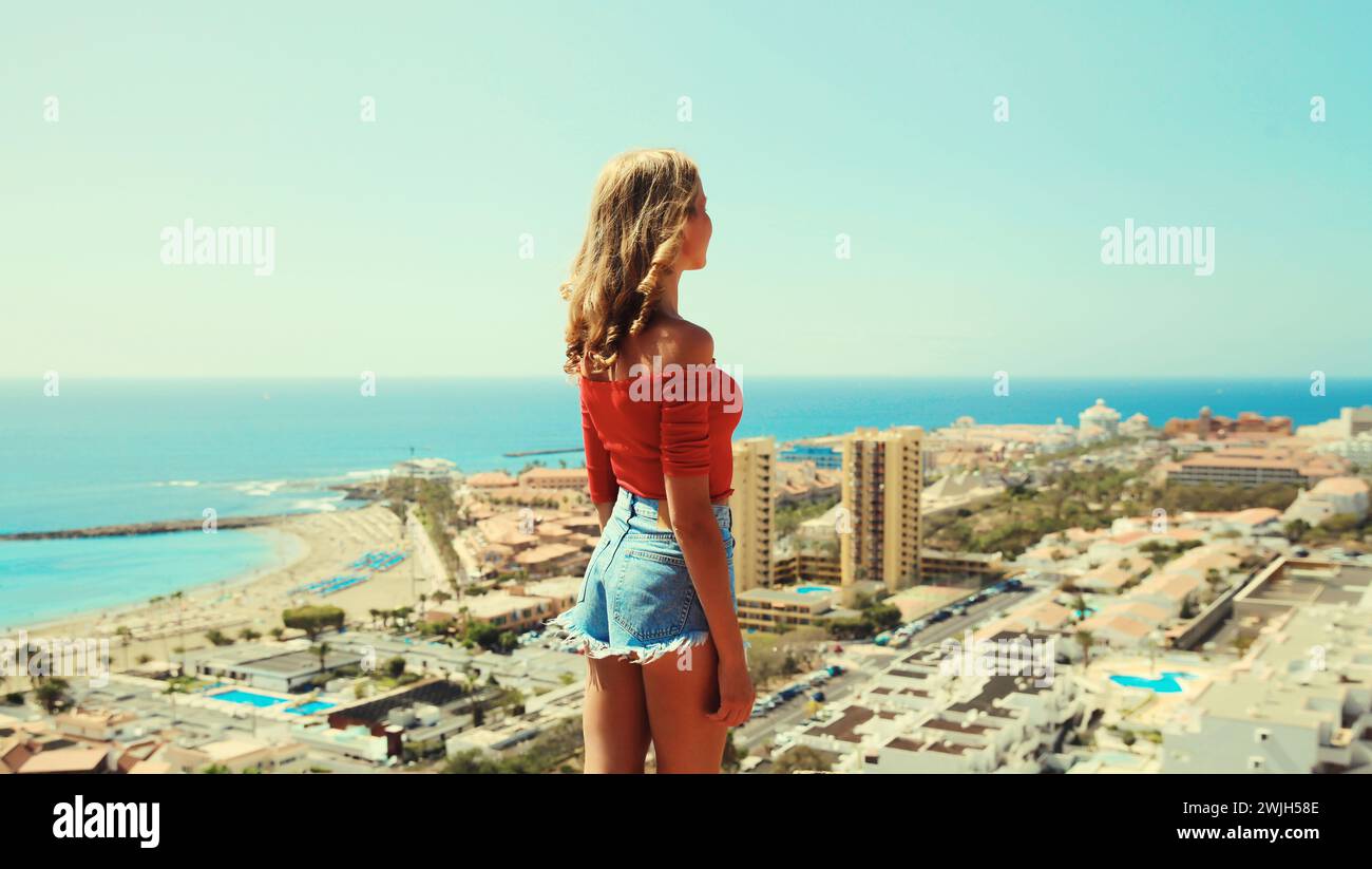 Summer vacation, beautiful young woman tourist on top of the mountain ...