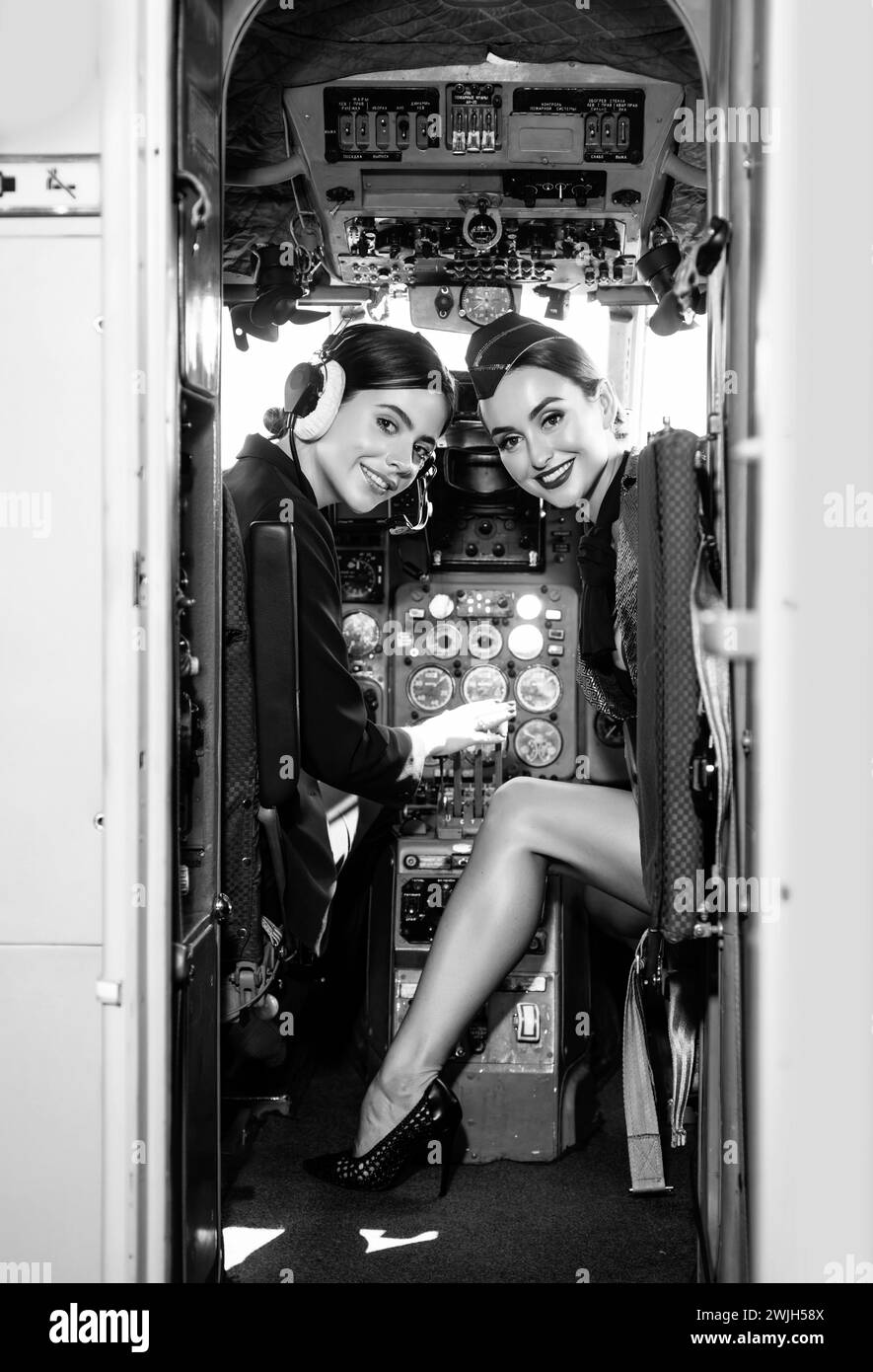 Two women pilots smiles and wishes a successful flight. Trainee Pilot and Flight Instructor in ...