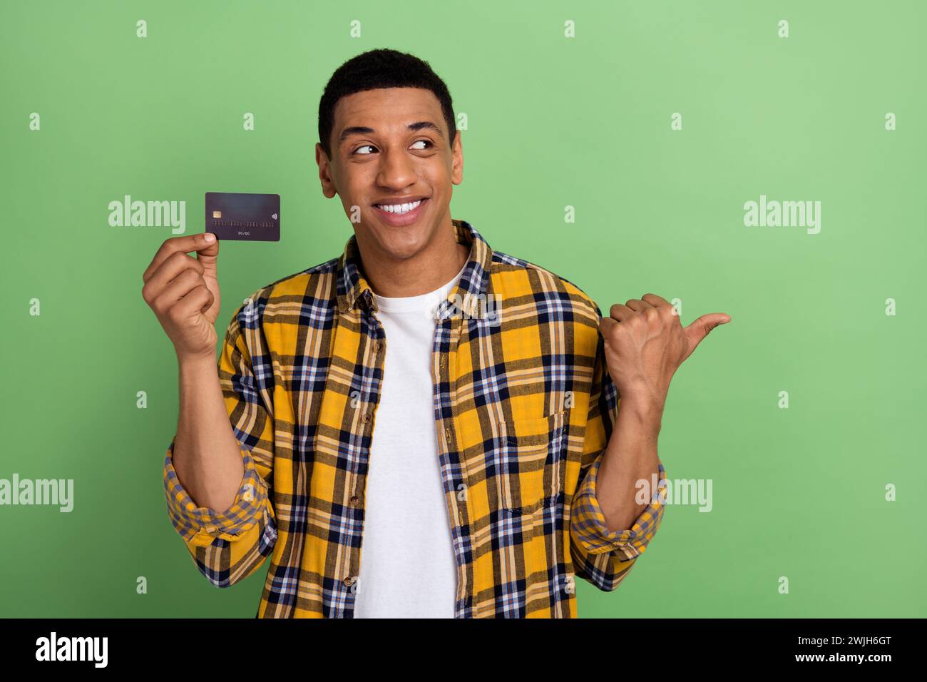Photo of young guy begin his business pointing finger advert for debit ...