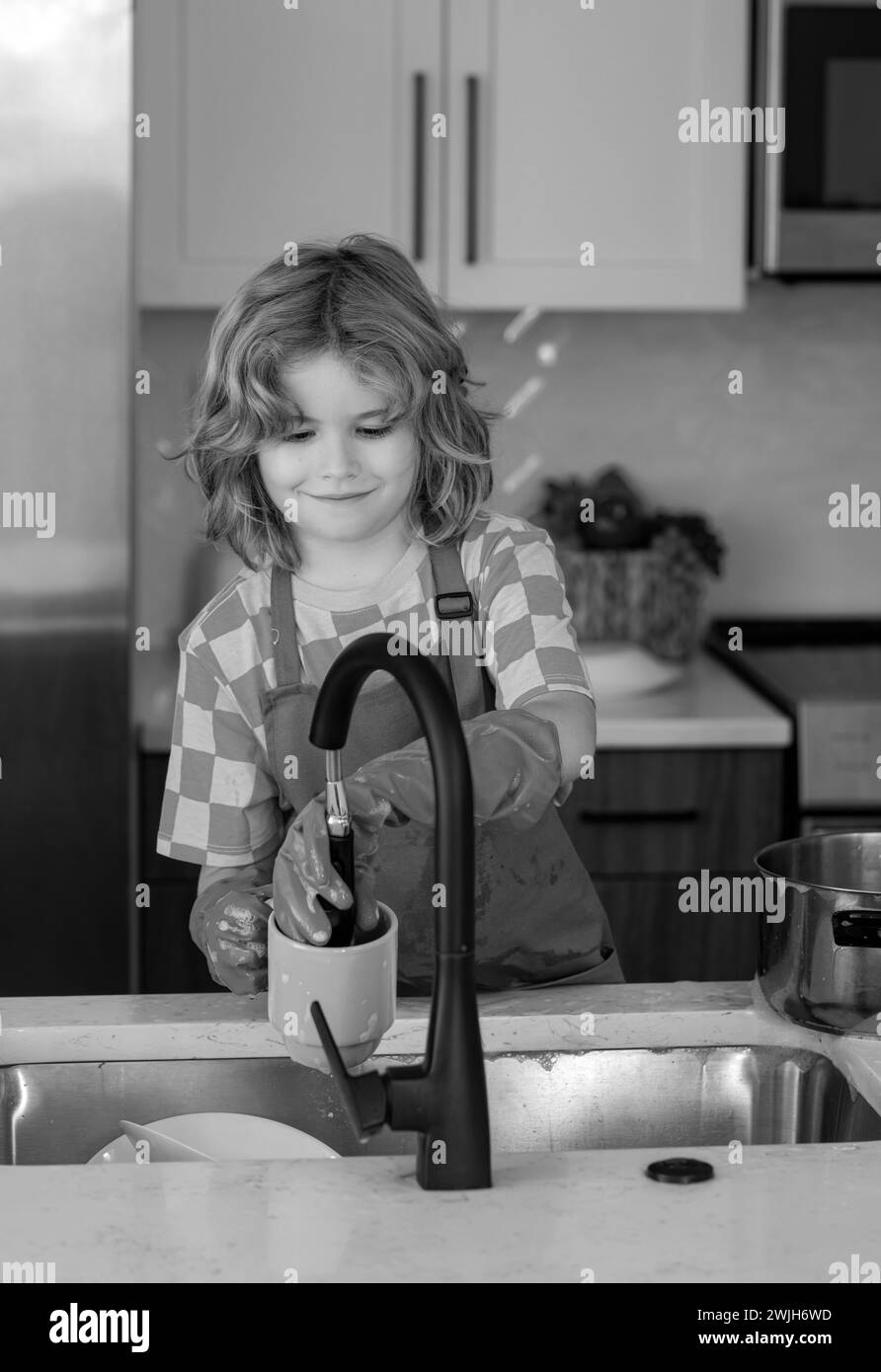 Dish washing concept. Little housekeeper. Child washing and wiping ...