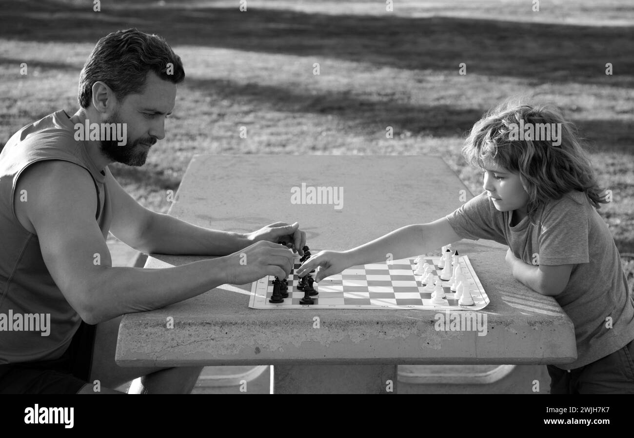 Father and son playing chess spending time together in park. Child ...