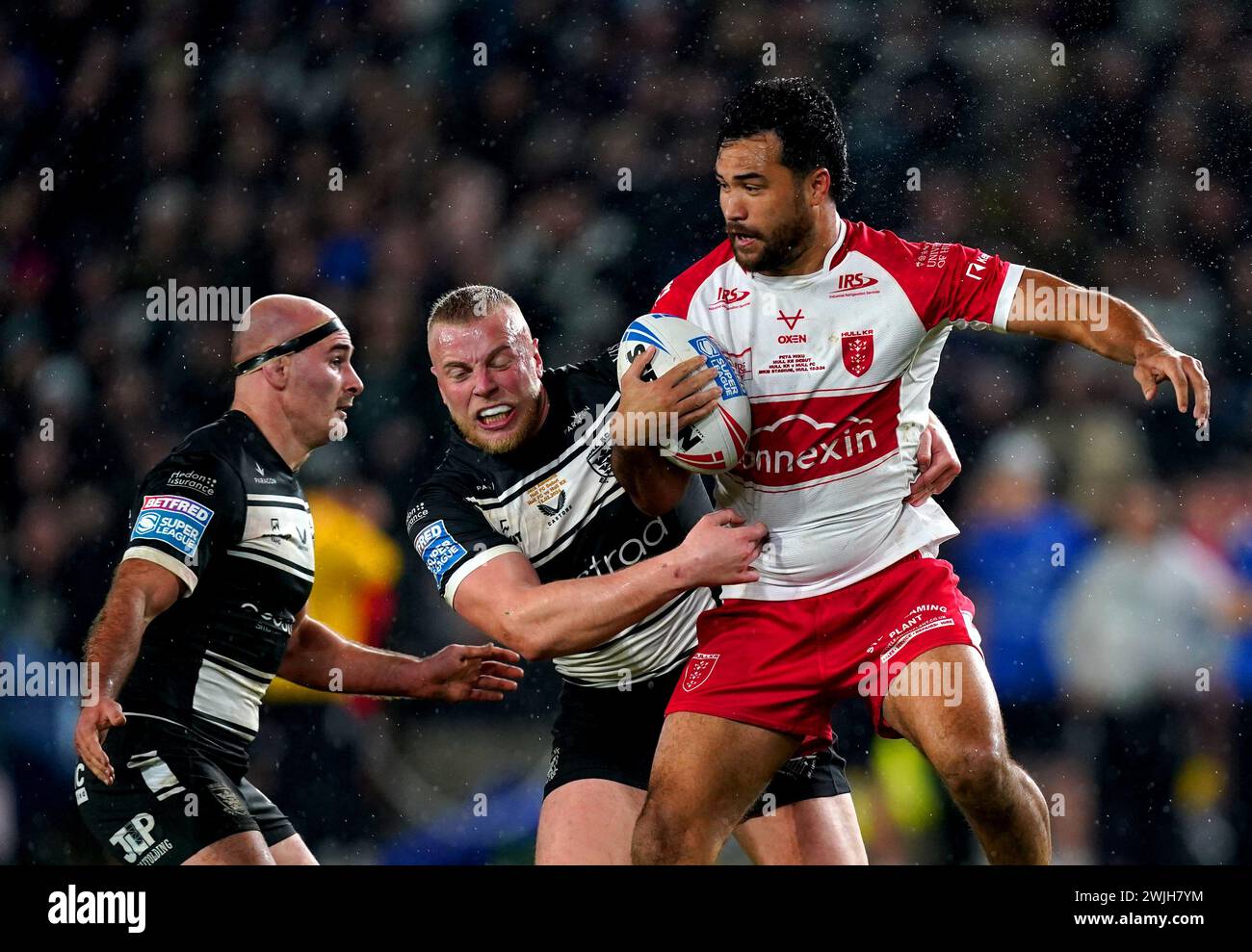 Hull KR's Peta Hiku (right) is tackled by Hull FC's Jack Ashworth during the Betfred Super ...
