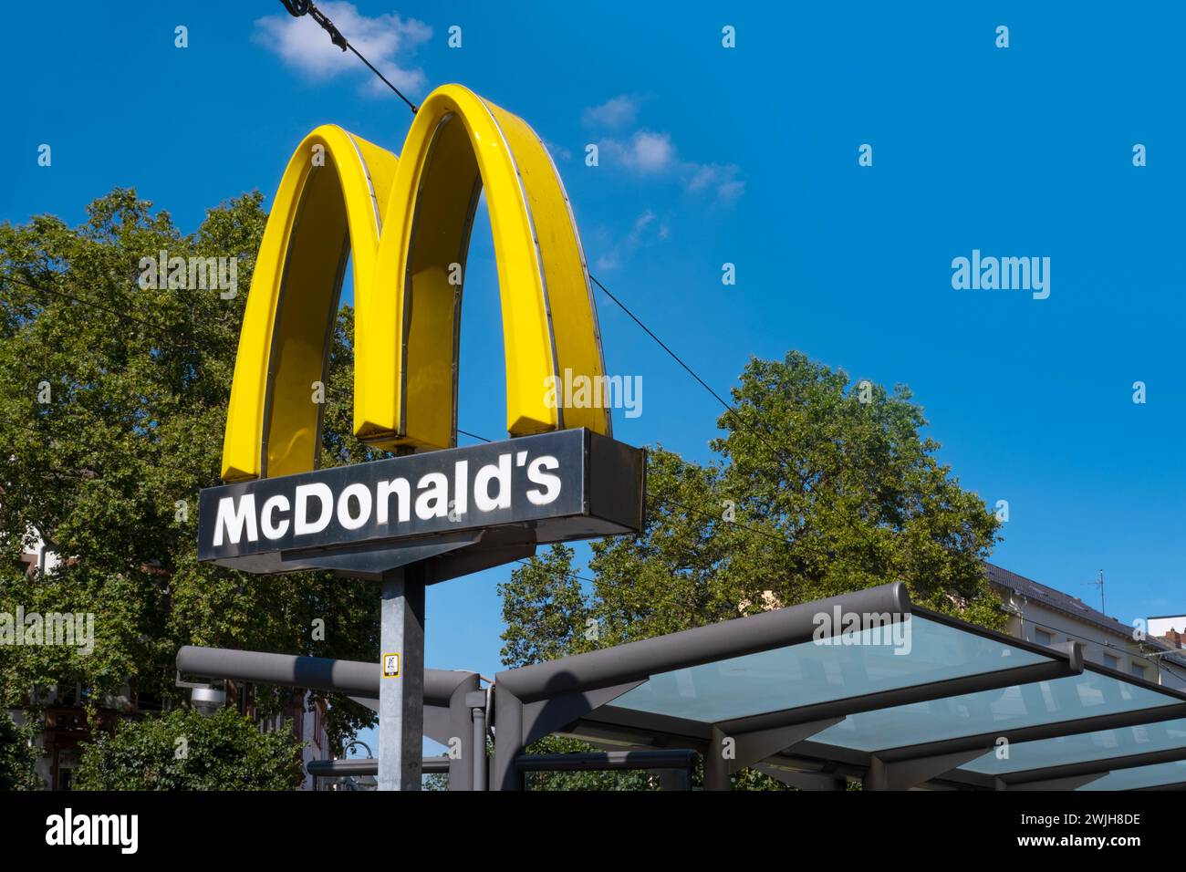 yellow signboard, McDonald's logo on street, fastfood restaurant chain ...