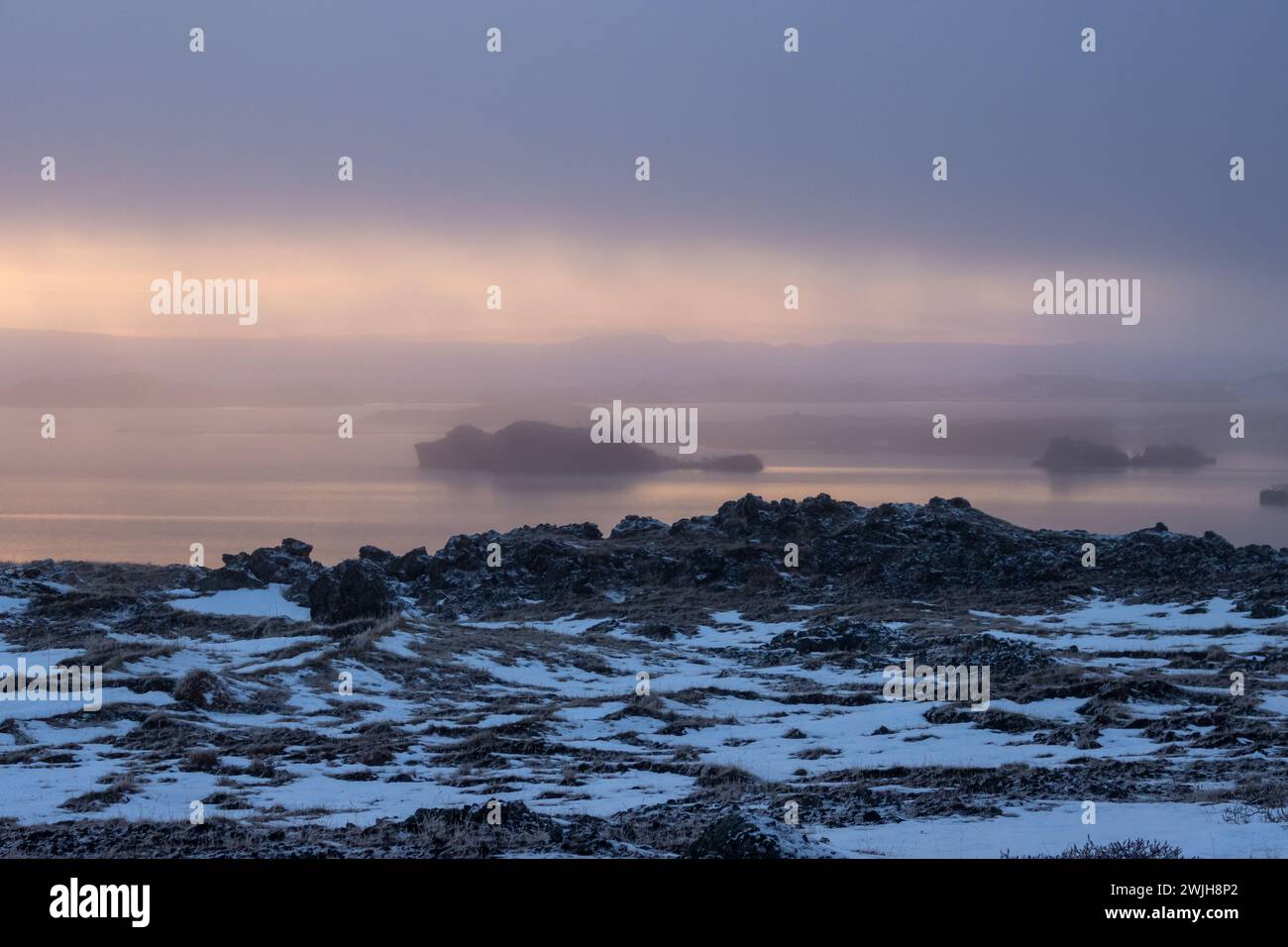 Colorful sunset at the lake. Littlebit of snow on the coast. Sky with ...