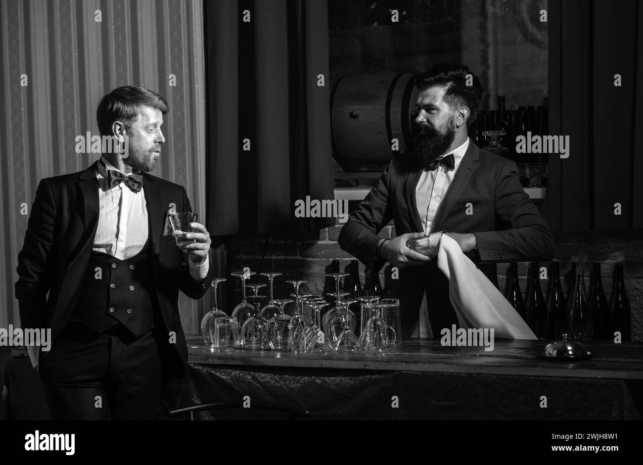 Bearded bartender giving his client a drink. Communication at pub ...