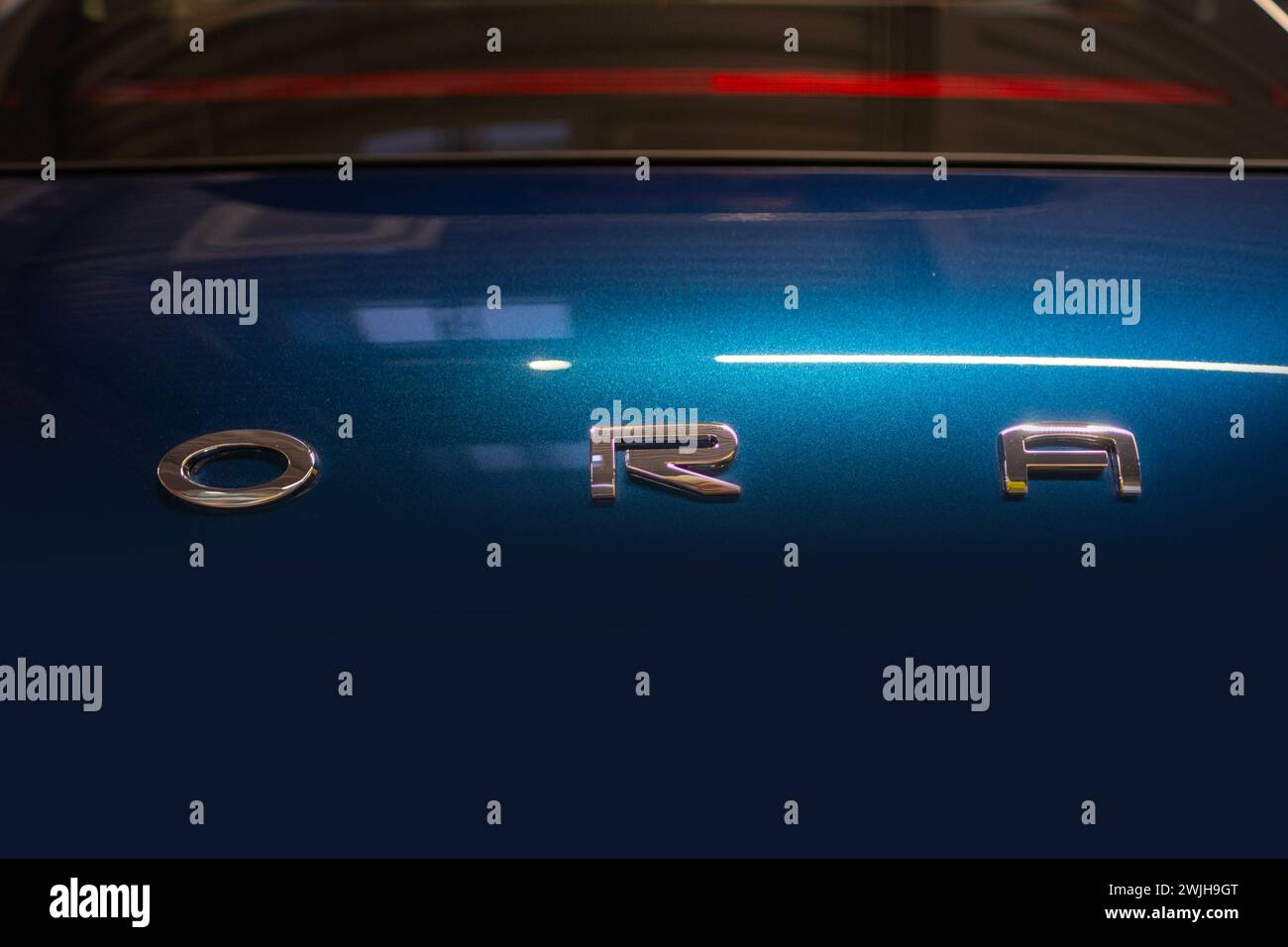 Logo on cap close-up, blue electric car GWM ORA 03, automobile details ...